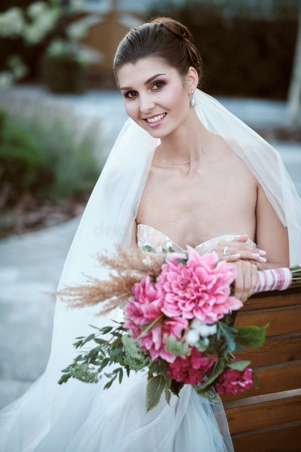 Beautiful Bride Posing in Her Wedding Day Stock Photo - Image of garden ...