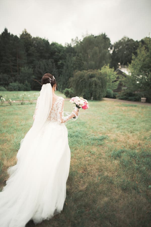 Beautiful Bride Posing in Wedding Dress Outdoors Stock Photo - Image of ...