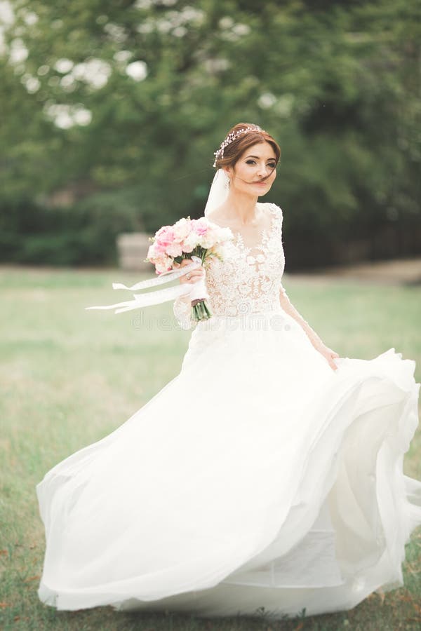 Beautiful Bride Posing in Wedding Dress Outdoors Stock Image - Image of ...