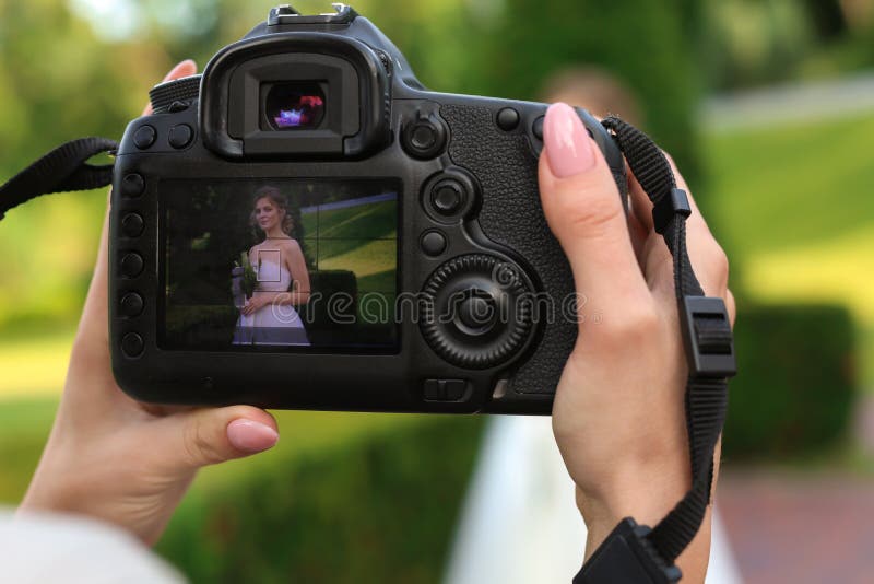 Beautiful Bride on Screen of Professional Photo Camera Outdoors ...