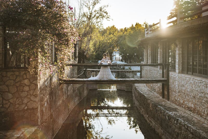 Beautiful Bride Standing on Wooden Rustic Bridge at Sunset Time Stock ...