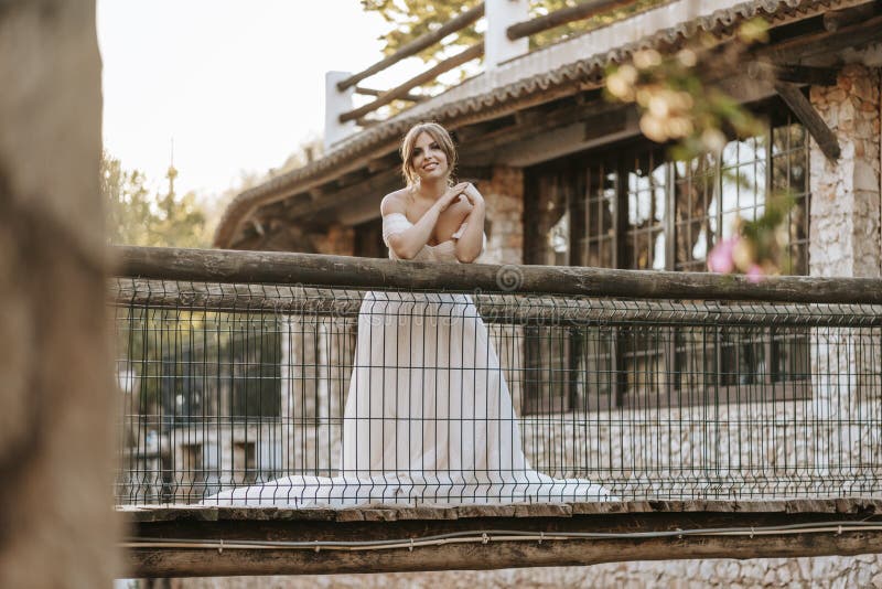 Beautiful Bride Standing on Wooden Rustic Bridge at Sunset Time Stock ...