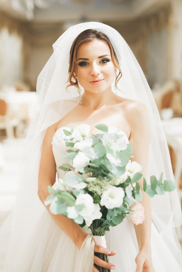 Beautiful Bride with Wedding Bouquet Posing in Hotel Stock Photo ...