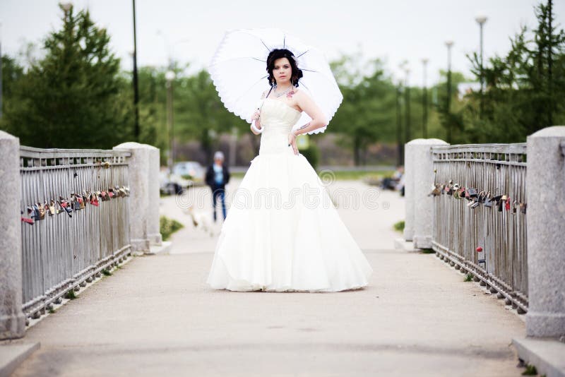 Bride with white umbrella stock photo. Image of style - 18690596