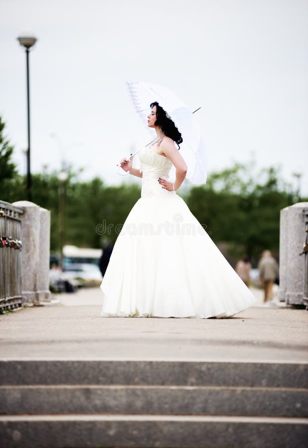 Bride with white umbrella stock photo. Image of style - 18690596