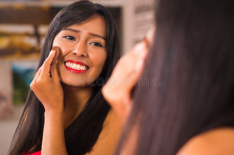 Beautiful Brunette Applying Make Up while Smiling Happily, Seen from ...
