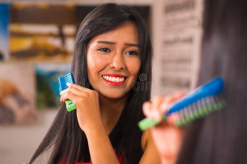 Beautiful Brunette Applying Make Up while Smiling Happily, Seen from ...