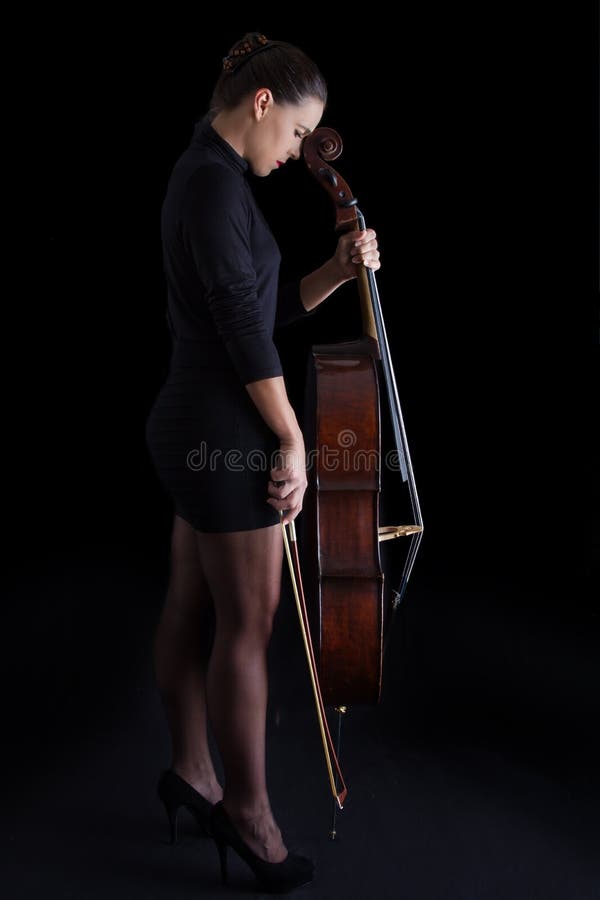 Beautiful Brunette Holding Cello with Selective Light in Black D Stock ...