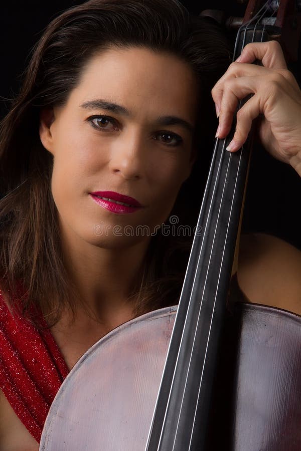 Beautiful Brunette Holding Cello with Selective Light in Red Dress ...