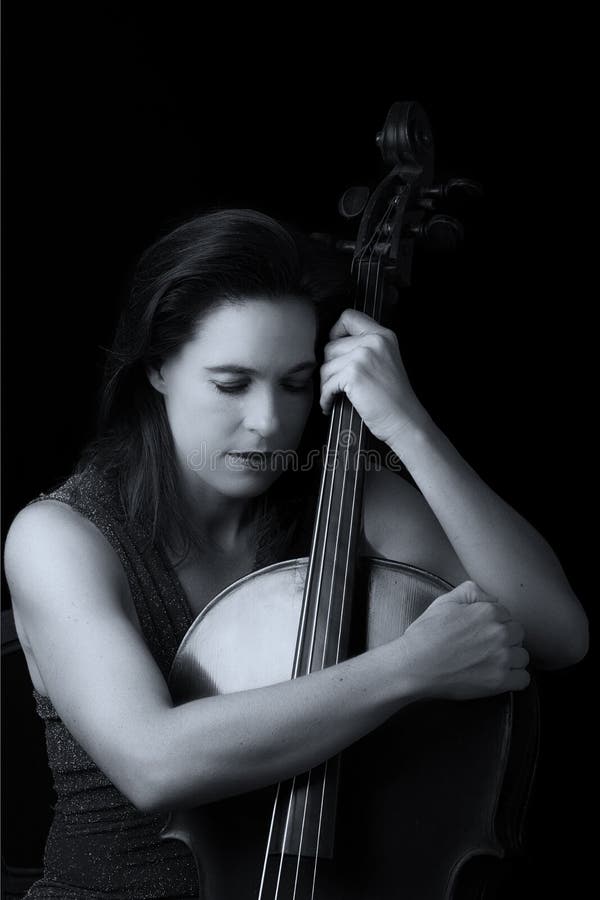 Beautiful Brunette Holding Cello with Selective Light in Red Dress ...