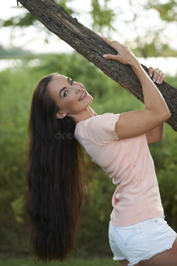 Beautiful Brunette Holding Tree Limb Stock Image - Image of caucasian ...