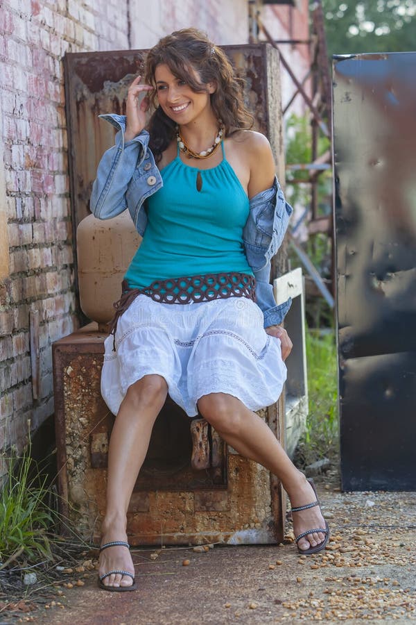 A Lovely Brunette Model Posing Outdoors With The Latest Fashions Stock