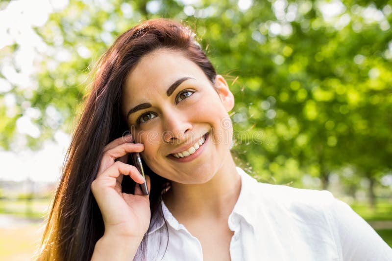Beautiful Brunette in the Park Making a Call Stock Image - Image of ...