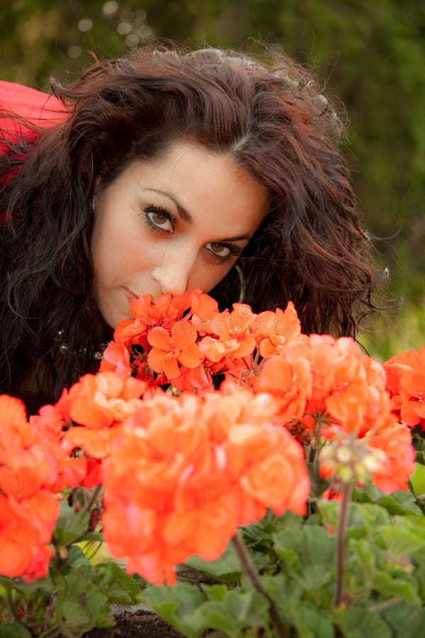 Beautiful Brunette is Smelling Flowers Stock Photo - Image of smelling ...