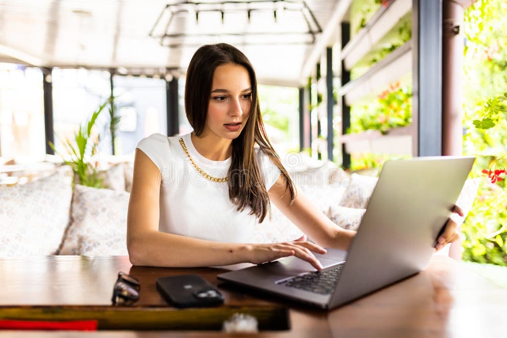 Beautiful Young Woman Using Notebook in Cafe Stock Image - Image of notebook, woman: 250287555
