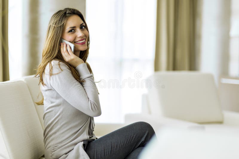 Beautiful Brunette Using a Phone in a Stylish House Stock Image - Image ...