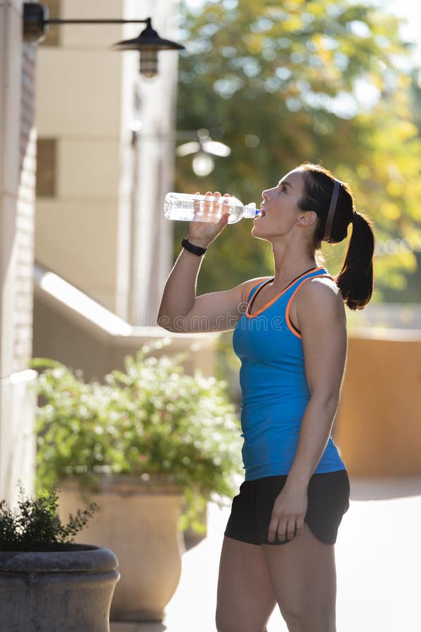 Beautiful Brunette Woman Drinking Water after Exercise Stock Image ...