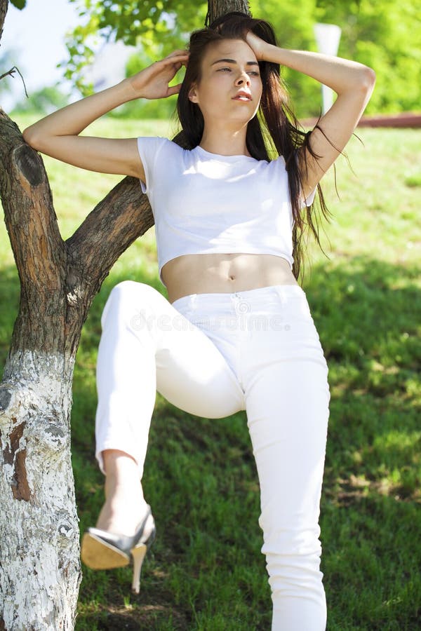 Beautiful Brunette Woman Posing Against Summer Park Bright Sunny