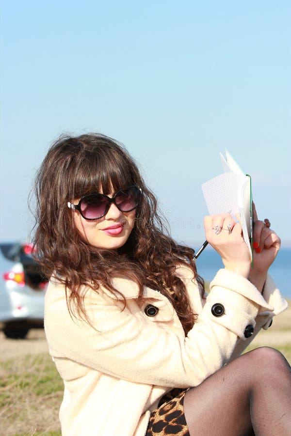 Beautiful Brunette Woman Taking Notes on a Pad, Camping Stock Image ...
