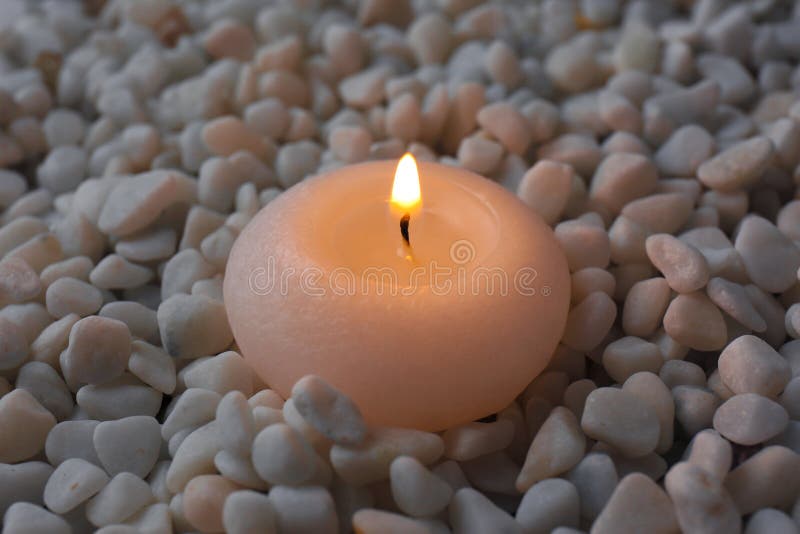 Beautiful Burning Candle on White Stones Stock Photo - Image of ...