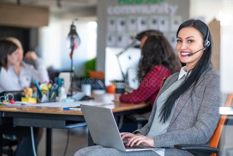 Beautiful Business People in Headsets are Using Computers and Smiling ...