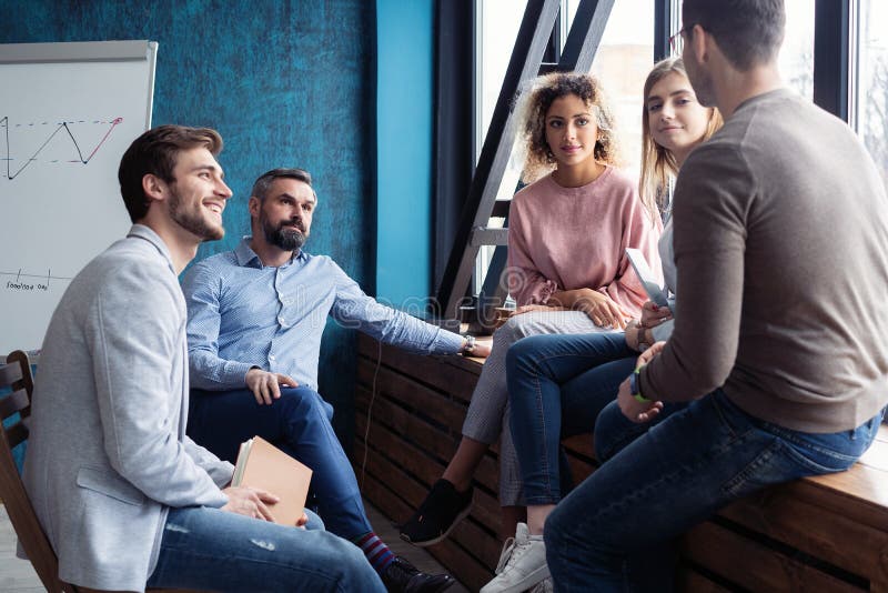 Beautiful Business People are Using Gadgets, Talking and Smiling during ...