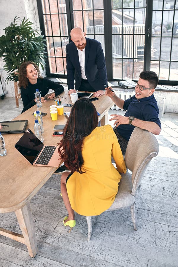 Beautiful Business People are Using Gadgets, Talking and Smiling during ...