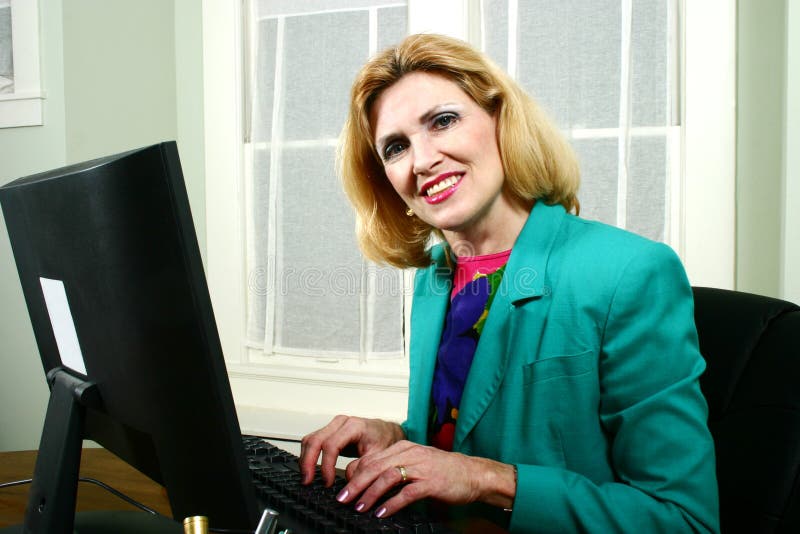 Beautiful Business Woman Smiling and Typing on Computer Stock Photo ...