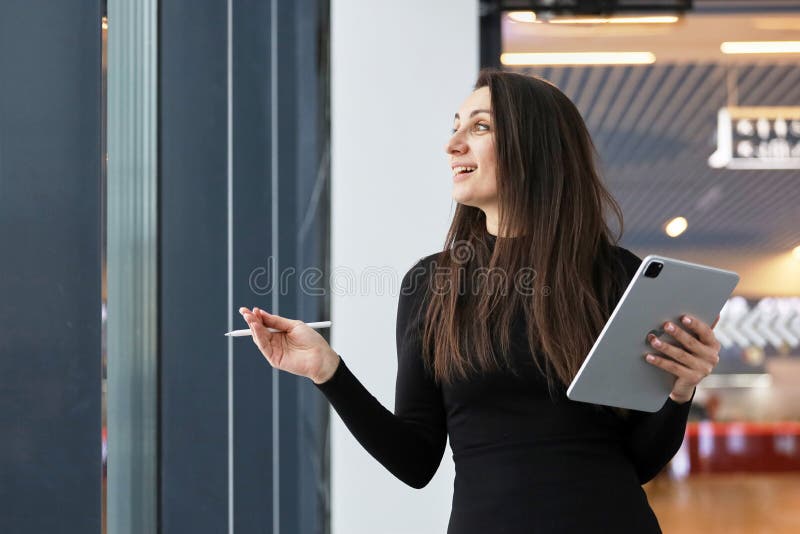 Beautiful Business Woman Using Tablet Computer Texting while Walking in ...