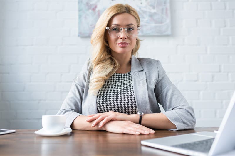 Beautiful Businesswoman Sitting at Table in Office and Looking Stock ...