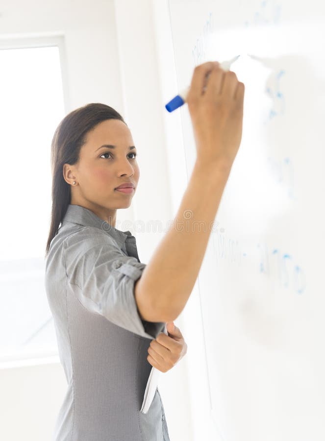 Businesswoman Writing on Whiteboard in Office Stock Image - Image of ...