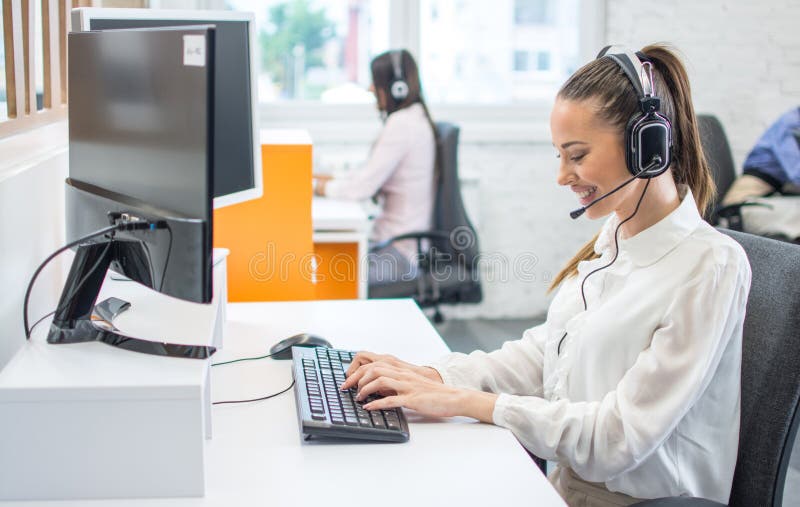 Beautiful Call Center Operator Woman in Headset Using Computer at ...