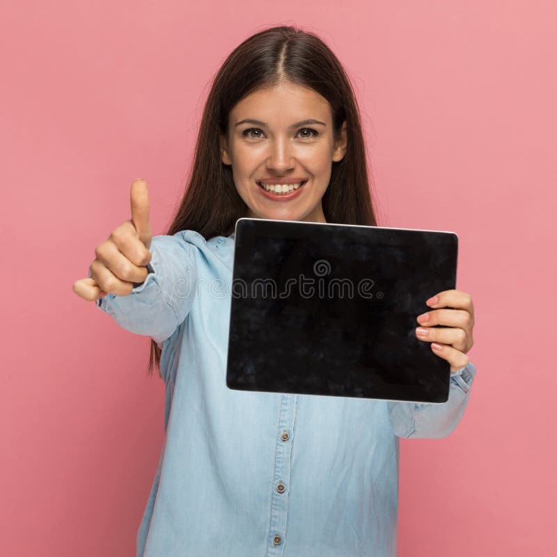 Casual Woman Giving a Thumbs Up while Holding a Tablet Stock Image ... Casual Woman Giving a Thumbs Up while Holding a Tablet Stock Image ...