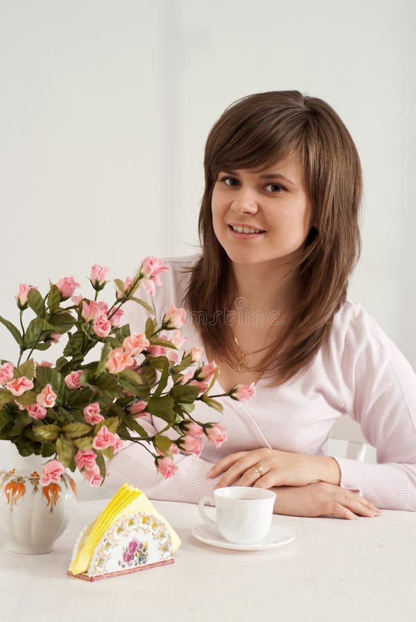 A Beautiful Caucasian Nice Girl Sitting at a Table Stock Photo - Image ...