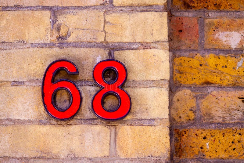 House Number 68 in Bright Red Digits on a Brick Wall Stock Photo ...