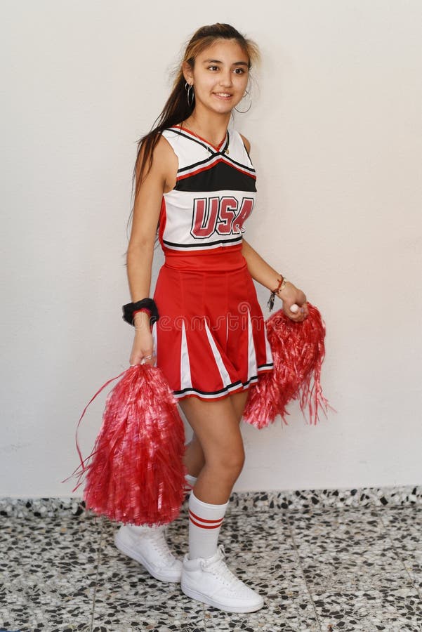 A Beautiful Cheerleader Dressed in a Red Uniform Stock Photo - Image of ...