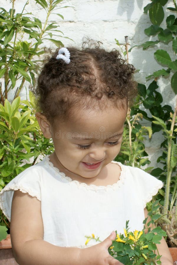 Beautiful Child with Flowers Stock Photo - Image of sunshine, flower ...