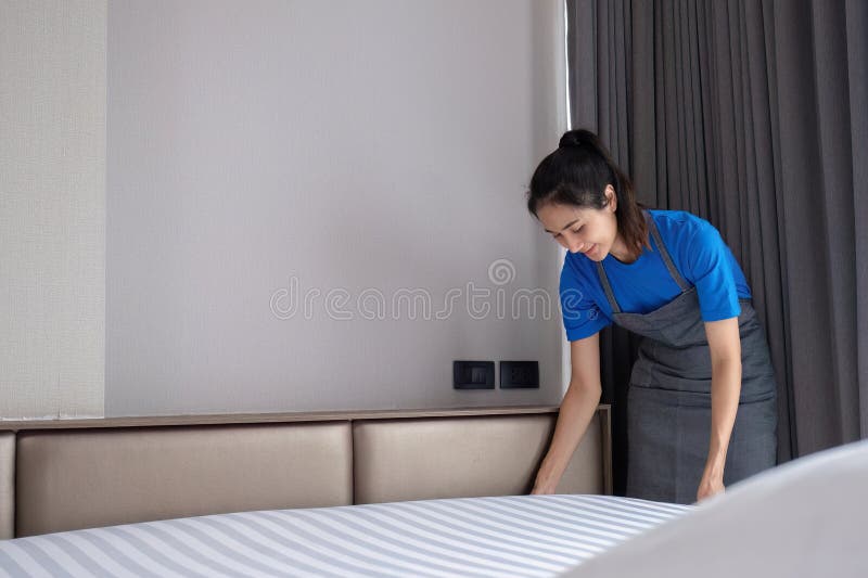 Beautiful Cleaning Lady Clean and Prepare the Bedding on the Bed ...