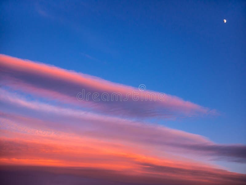 Beautiful Colorful Clouds at Sunset with a Moon in the Corner of the ...