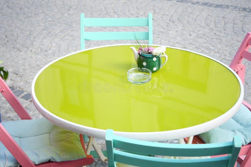 A Beautiful and Colorful Outdoor Dining Table Set that Includes Chairs ...