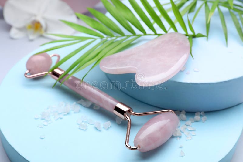 Beautiful Composition with Gua Sha Stone and Face Roller on Color ...