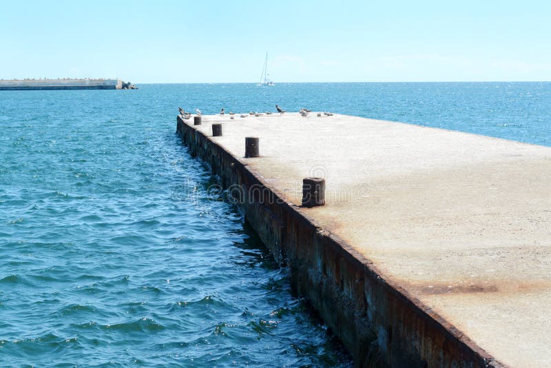 Beautiful Concrete Pier in Sea on Sunny Day, Space for Text Stock Photo ...