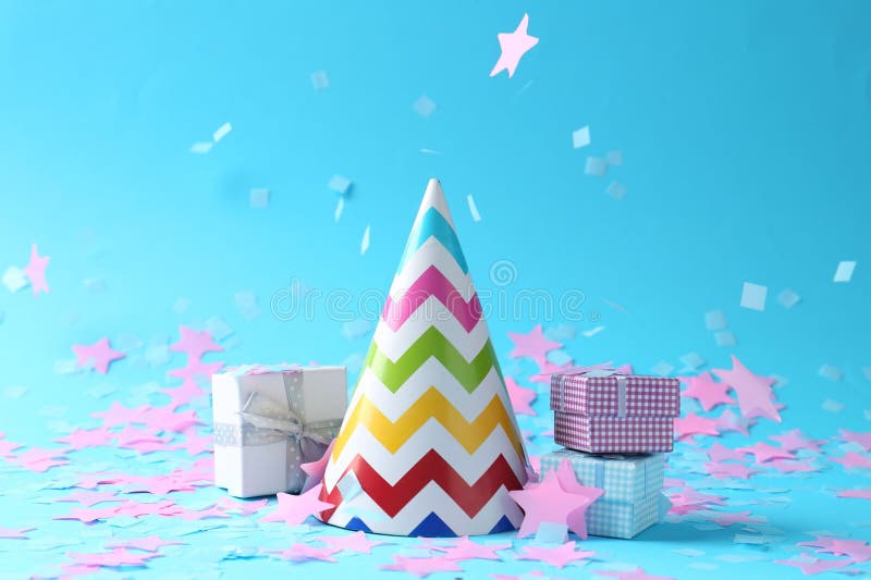 Beautiful Confetti Falling on Party Hat and Gift Boxes Against Light ...