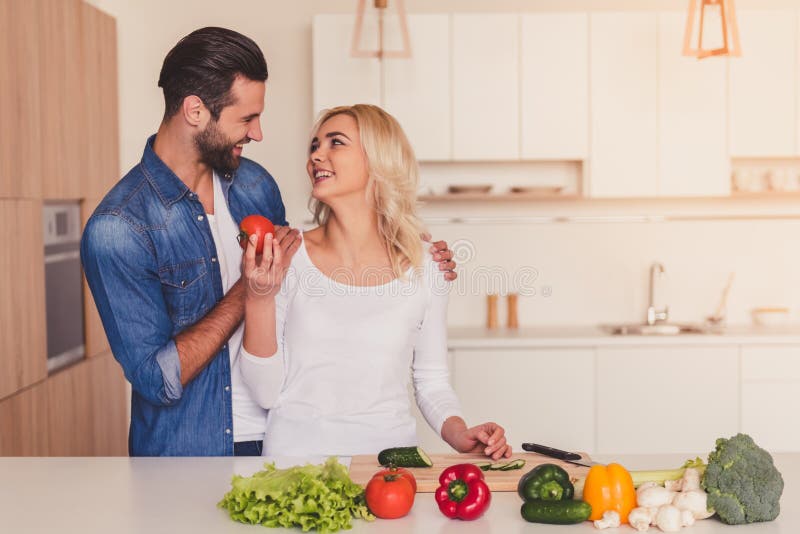 Beautiful couple cooking stock photo. Image of kitchen - 89787160