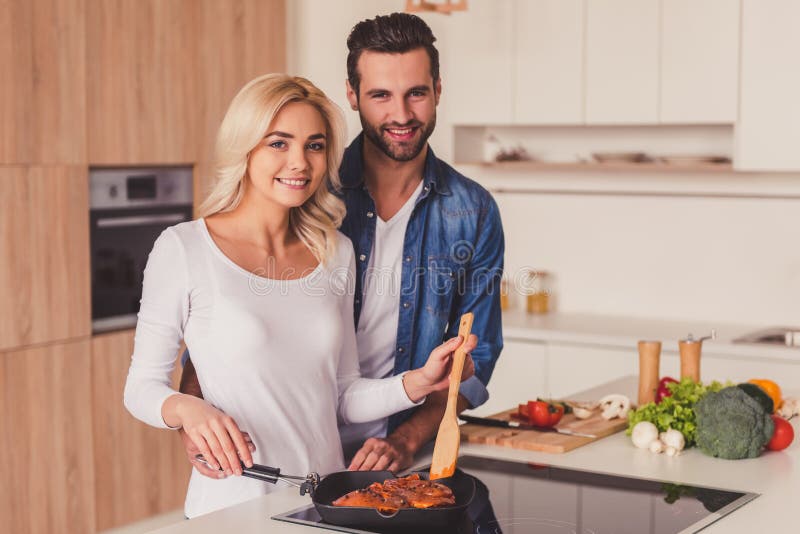 Beautiful couple cooking stock image. Image of home, drink - 89787903