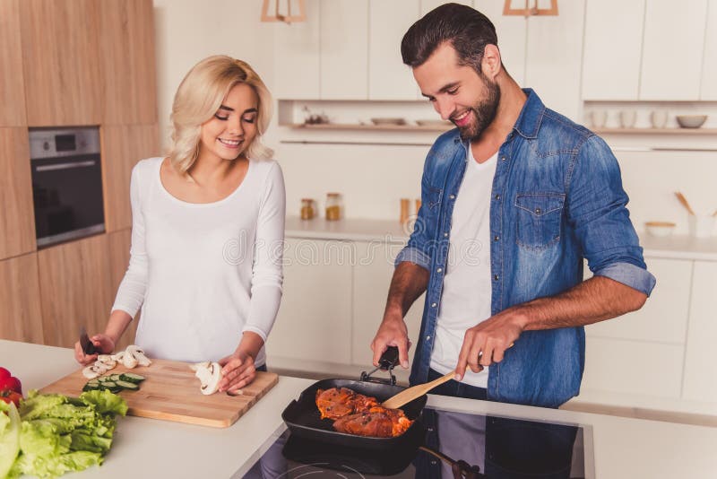 Beautiful couple cooking stock image. Image of drink - 89787517