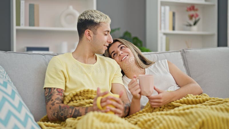 Beautiful Couple Drinking Coffee Sitting on Sofa at Home Stock Image ...