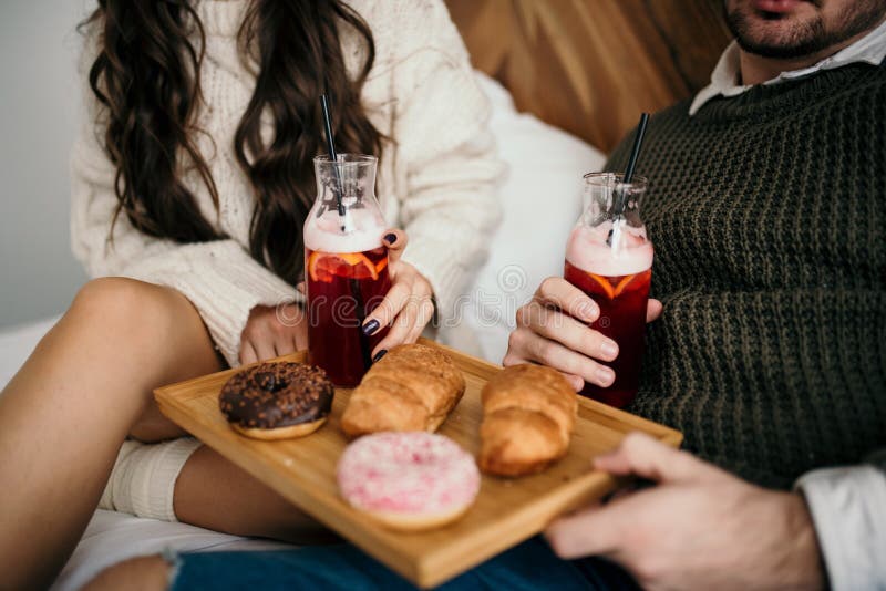 Beautiful Couple Eating Delicious Donuts in a Room Stock Image - Image ...