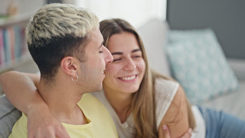 Beautiful Couple Sitting on Sofa Hugging Each Other Smiling at Home ...
