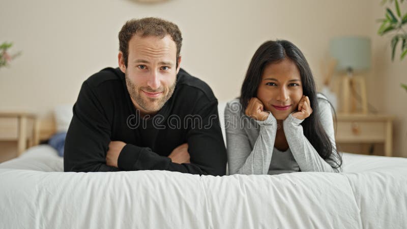 Beautiful Couple Lying on Bed Smiling at Bedroom Stock Photo - Image of ...